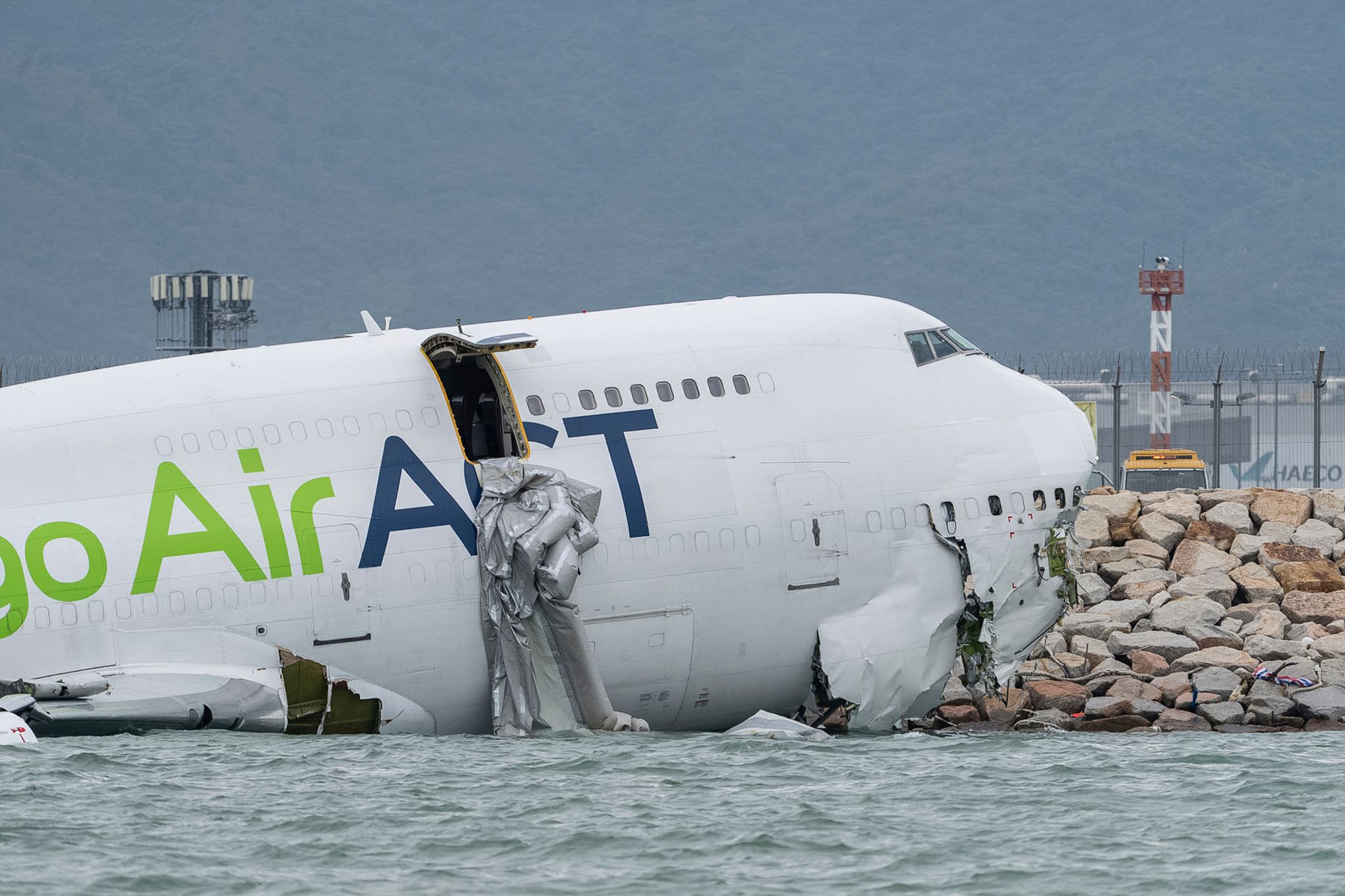 A cargo aircraft skids off a Hong Kong runway into the sea, killing 2 ...